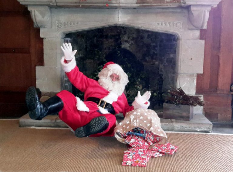 Santa Claus Father Christmas Comes Down The Chimney First And Foremost